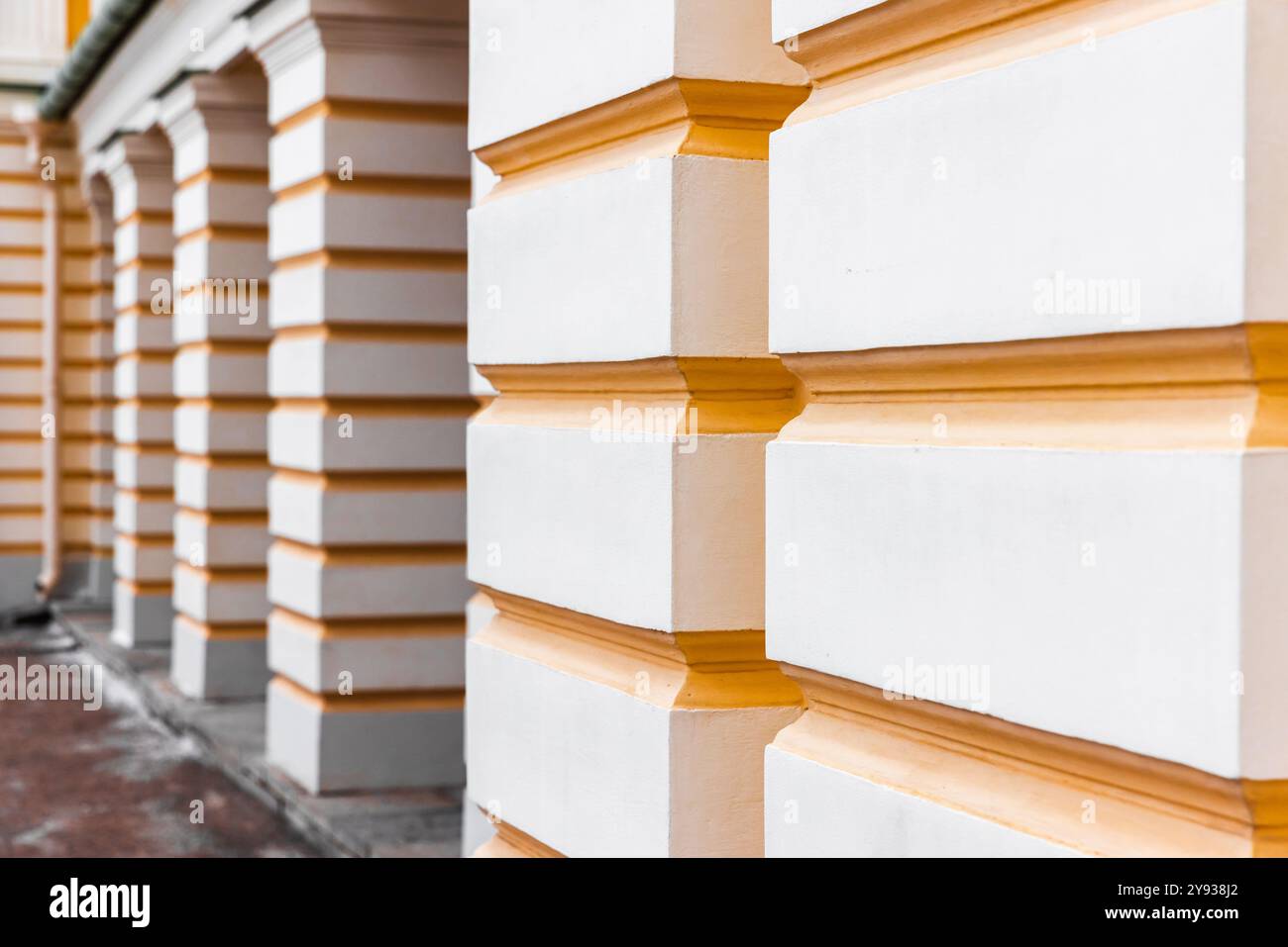 Classic architecture details, white pillars with yellow rustication ...