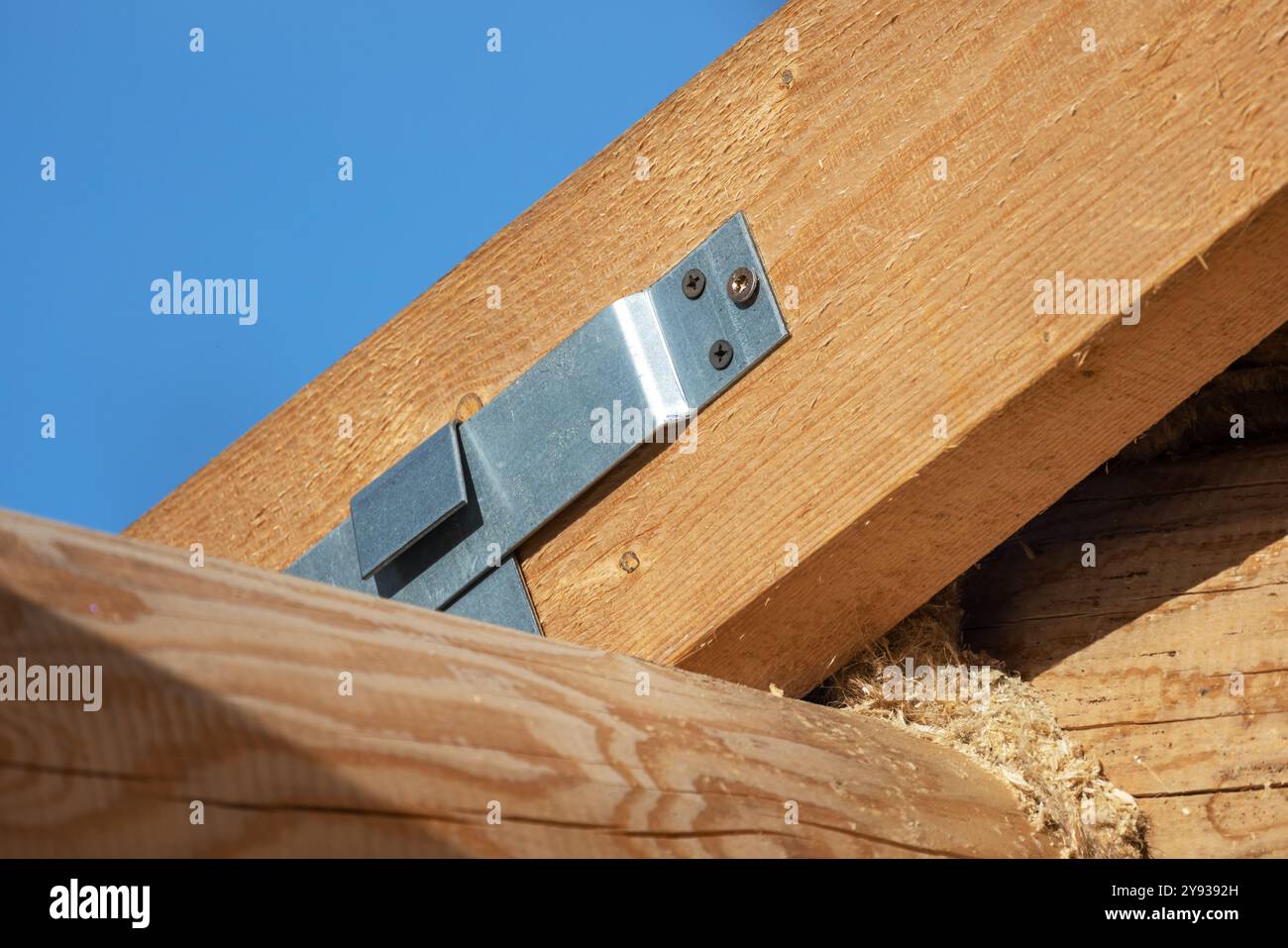 Wooden house is under construction. Sliding fastening of rafters to the ...