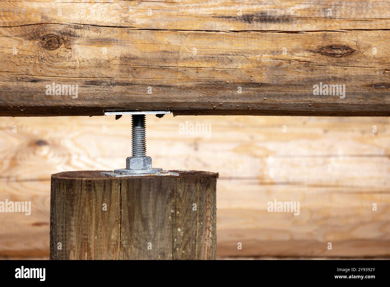 Log house roof is under construction. Close up photo of bolted ...