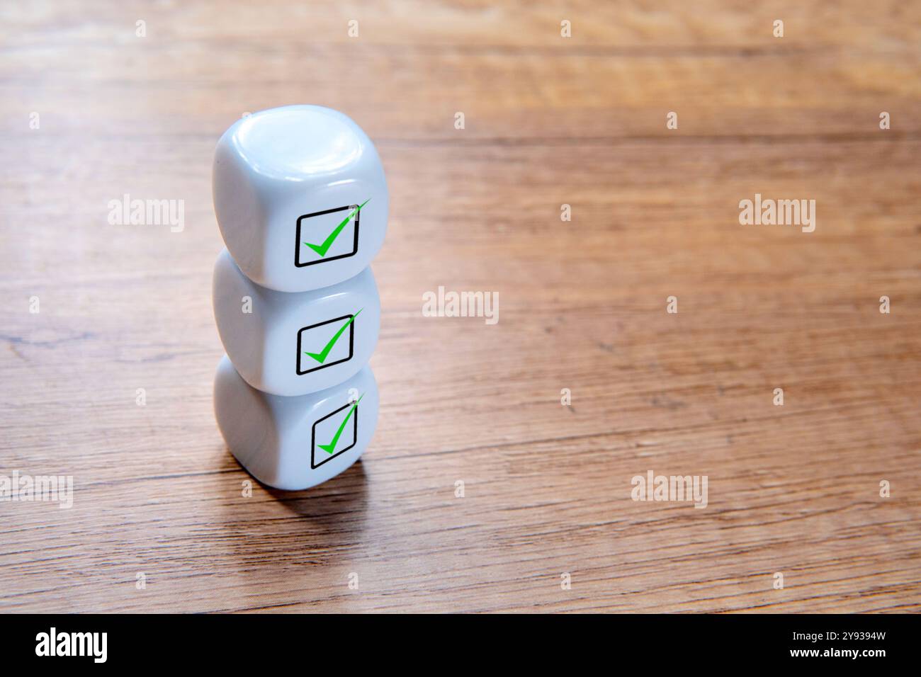 Three white dice with a green checkmark symbol. Checklist, approval and ...