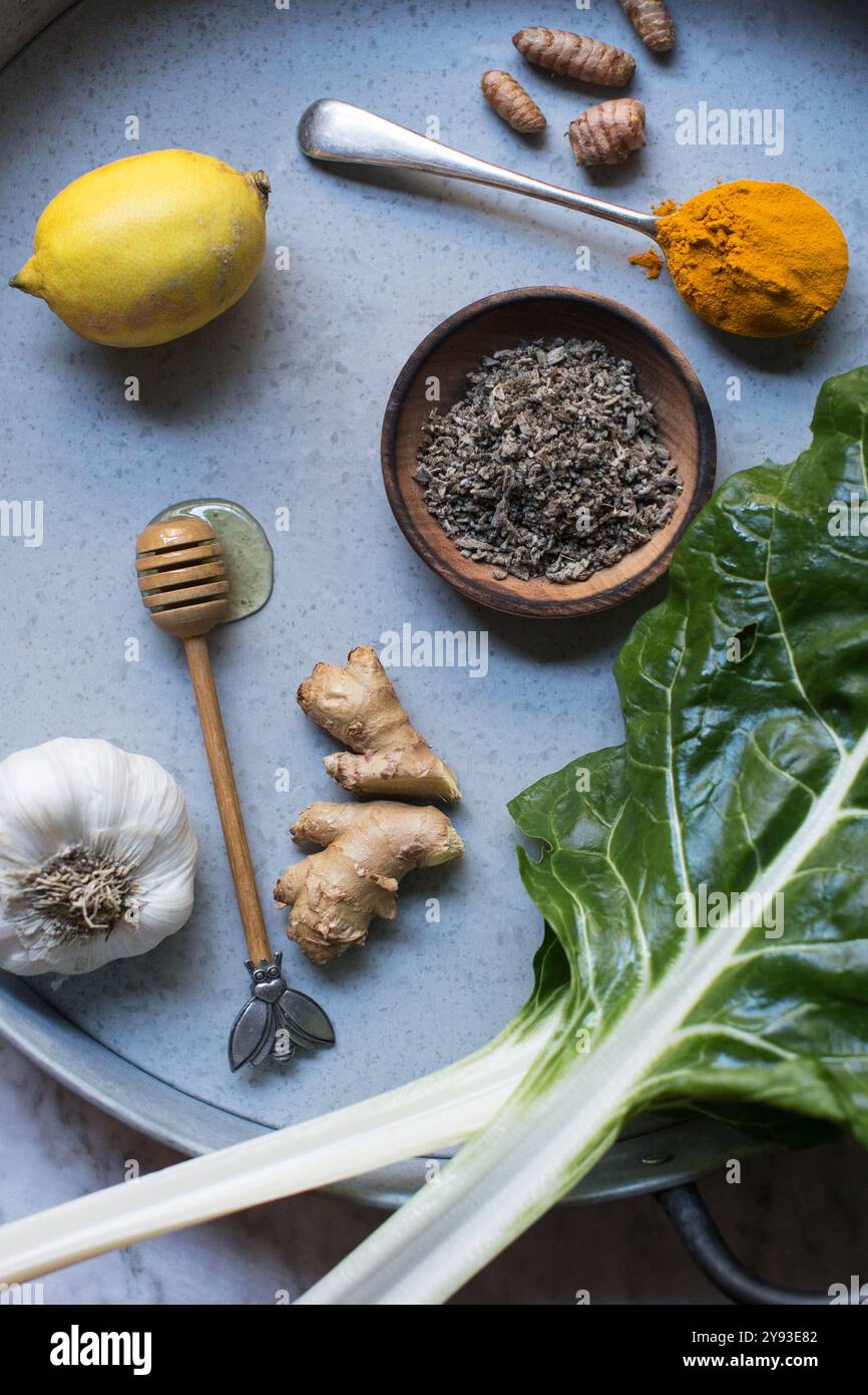 A collection of natural cold remedies: fresh turmeric, ginger, garlic ...