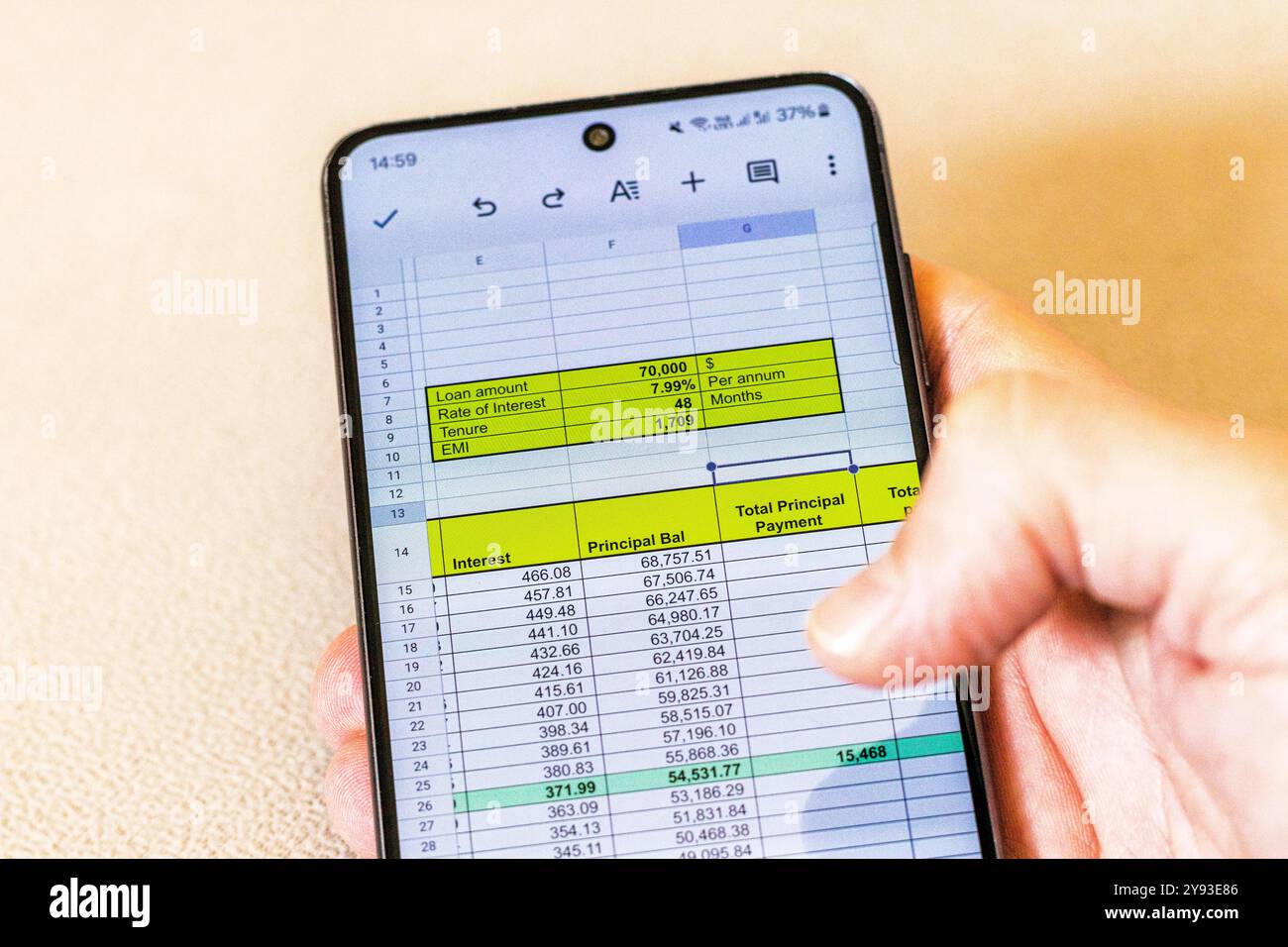 Man scrolling an excel sheet on the phone screen showing bank loan ...