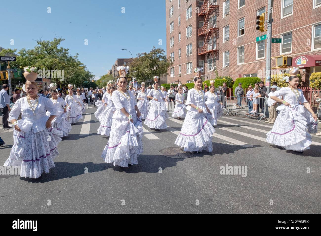 An age diverse group of Paraguayan women dance & march in white ...