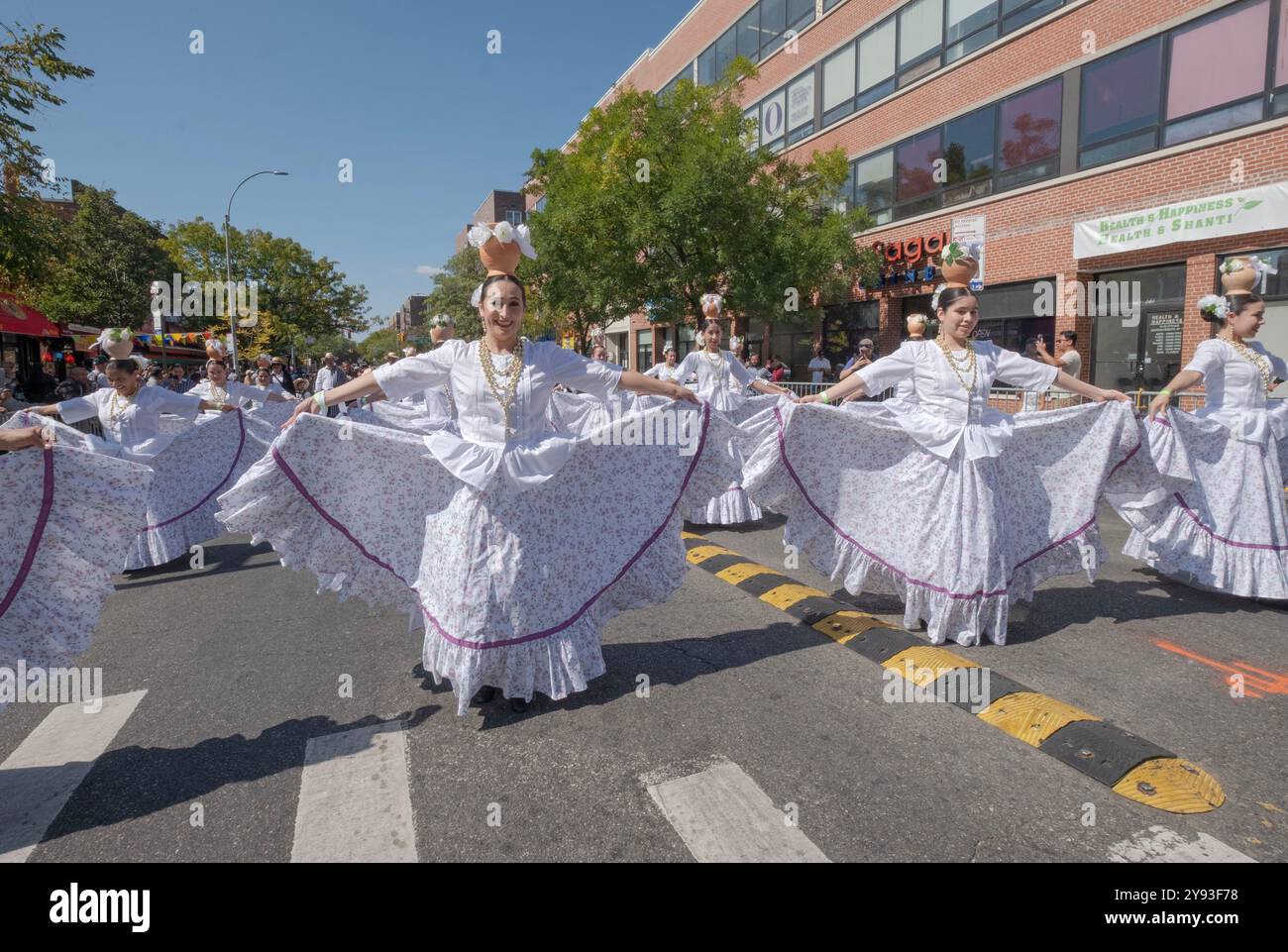 An age diverse group of Paraguayan women dance & march in white ...
