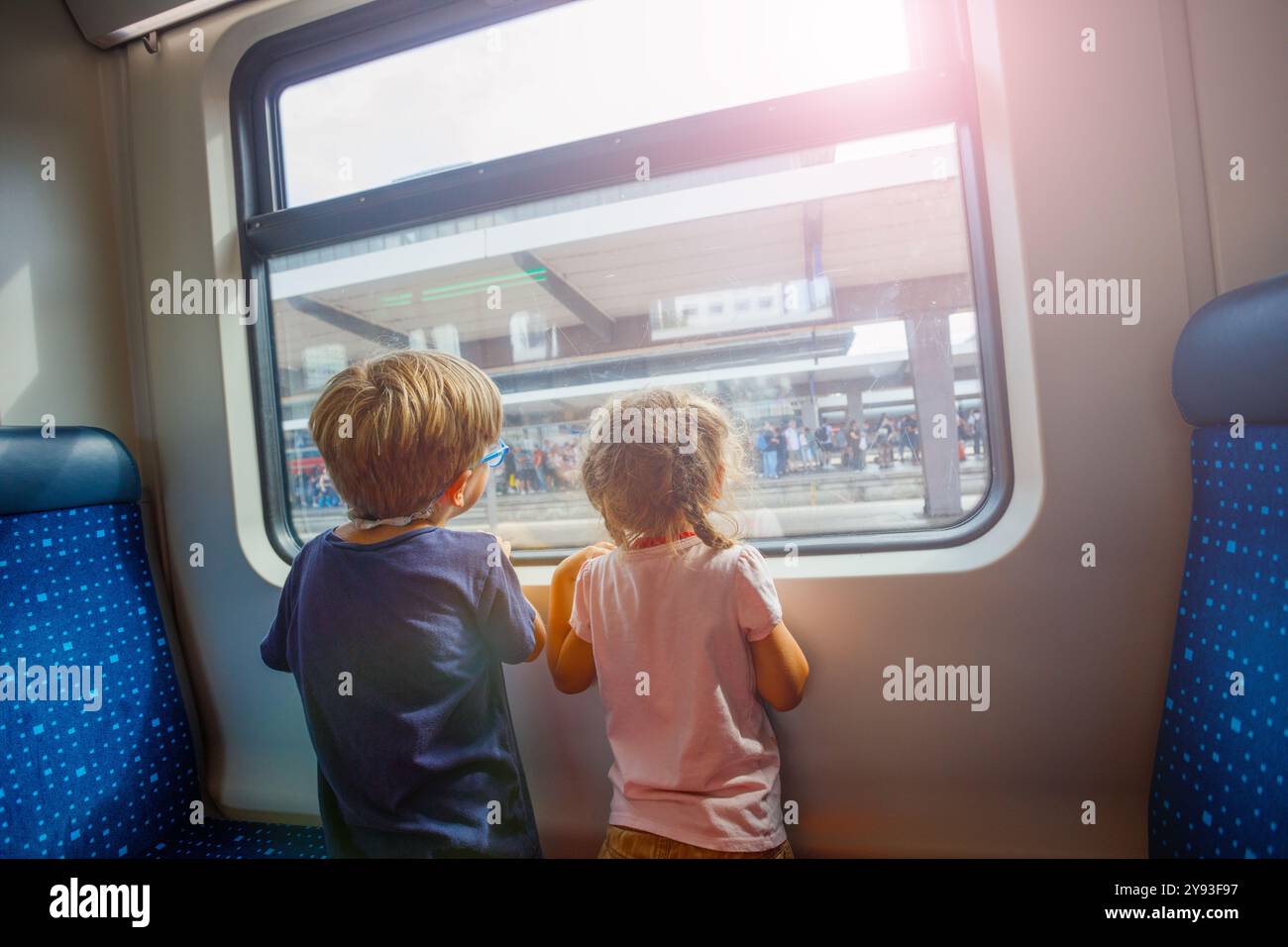 Two kids on a train, enjoying their journey look out the window Stock ...