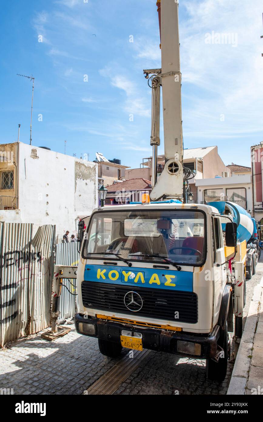 Lorry pumping ready-mixed concrete into a new building site, delivery ...