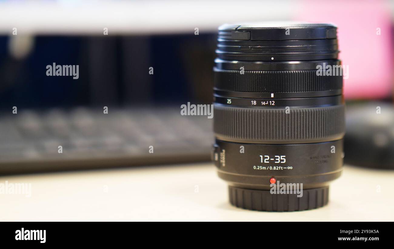 A close-up of a camera lens with detailed markings, resting on a ...