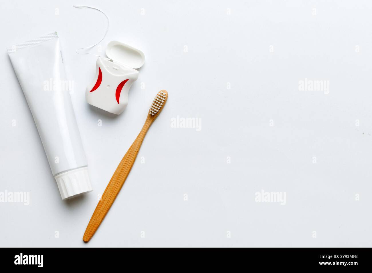toothpaste and toothbrush top view with copy space on colored ...