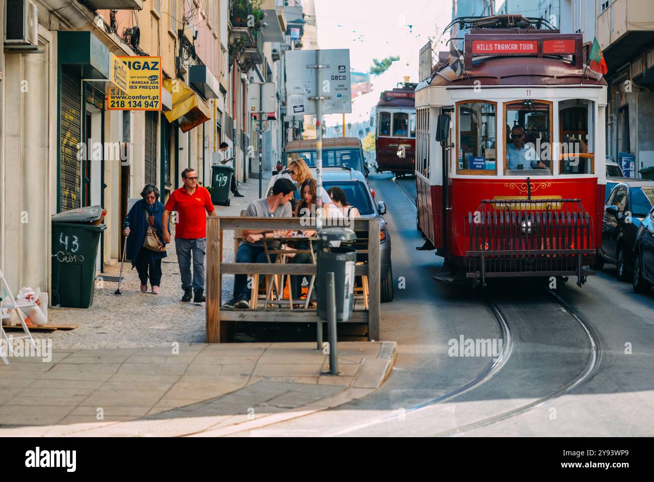 Two traditional red trams in the historic centre of Lisbon, Portugal ...