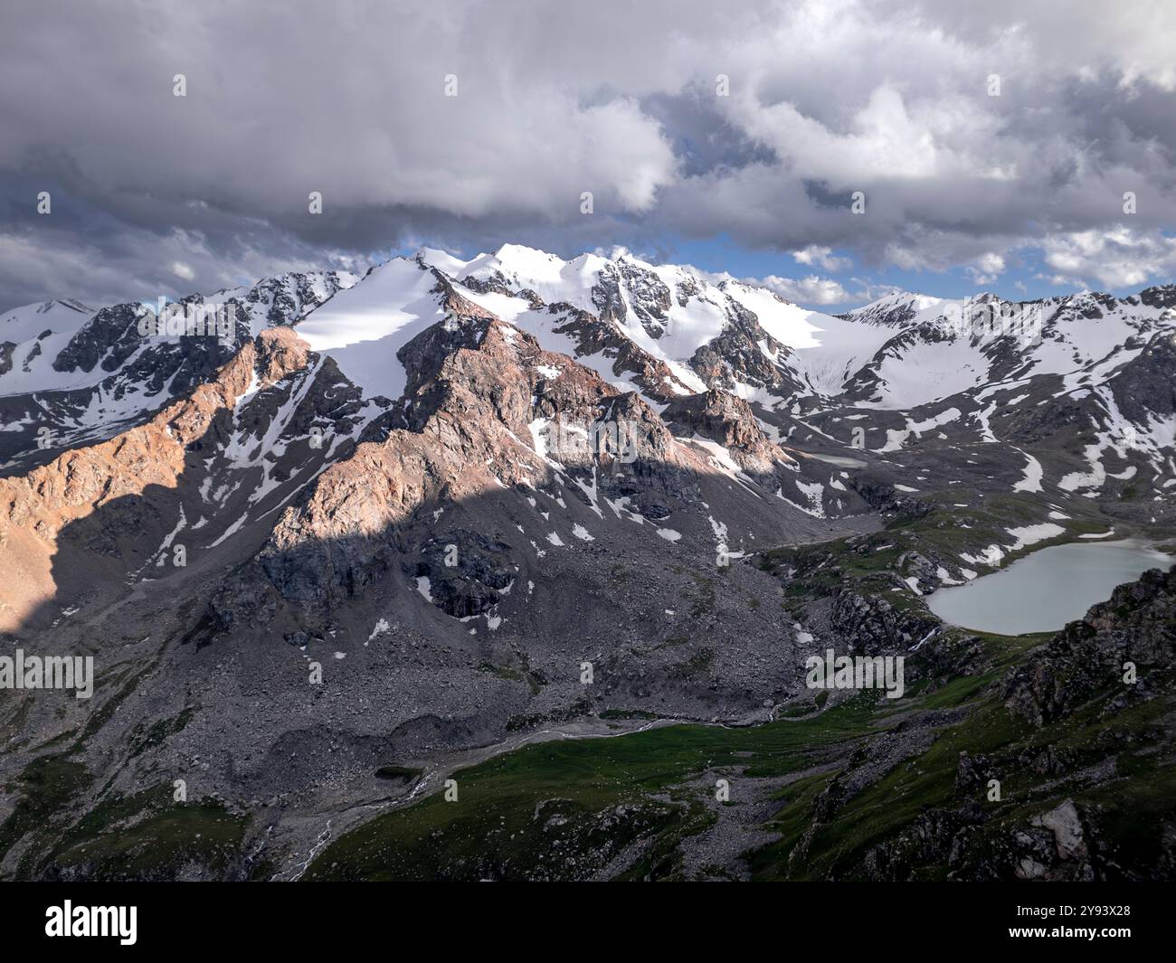 Snow-capped peaks and lush valleys at sunset showcased in a stunning ...