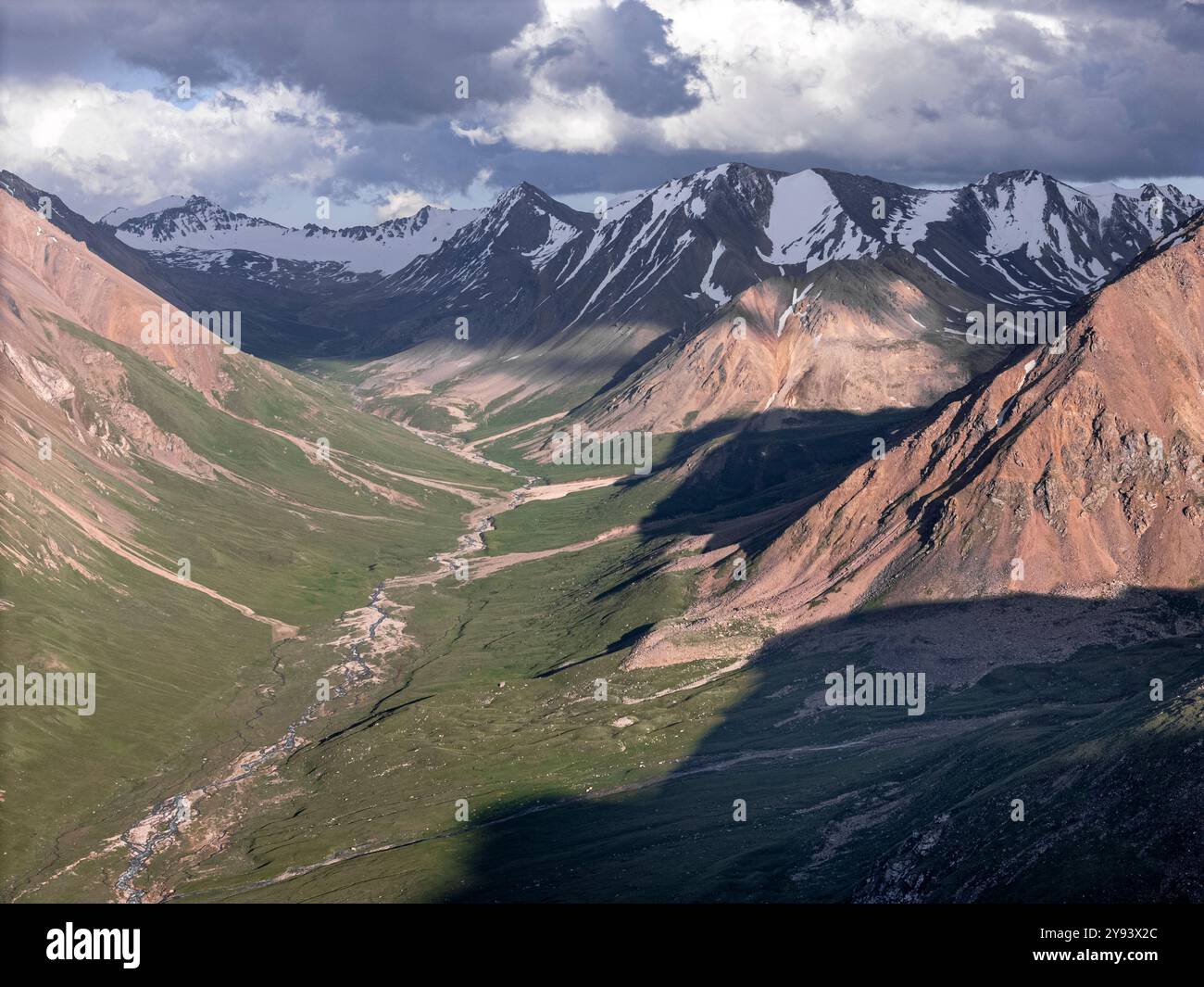 Snow-capped peaks and lush valleys at sunset showcased in a stunning ...