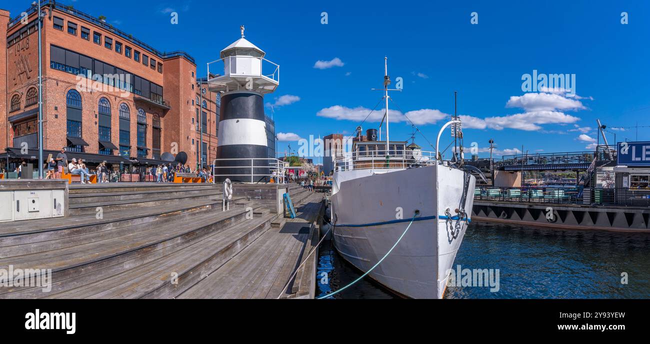 View of waterfront cafes and Oslo Lighthouse, Aker Brygge, Oslo, Norway ...