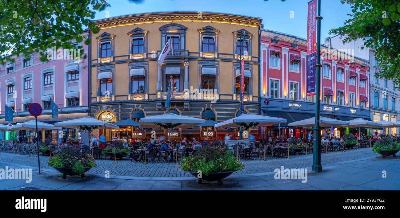 View of cafes, bars and architecture on Karl Johans Gate at dusk, Oslo ...