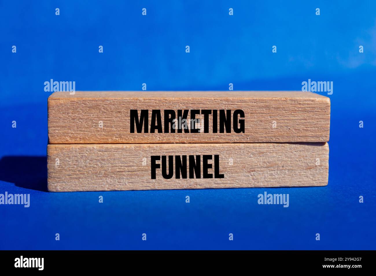 Marketing funnel message written on wooden blocks with blue background ...