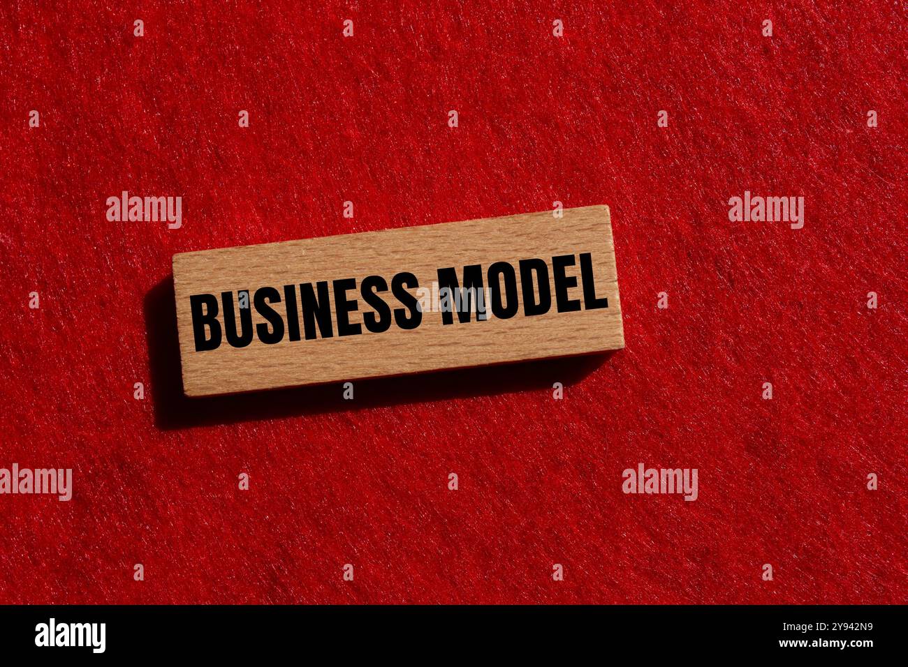 Business model message written on wooden block with red felt background ...