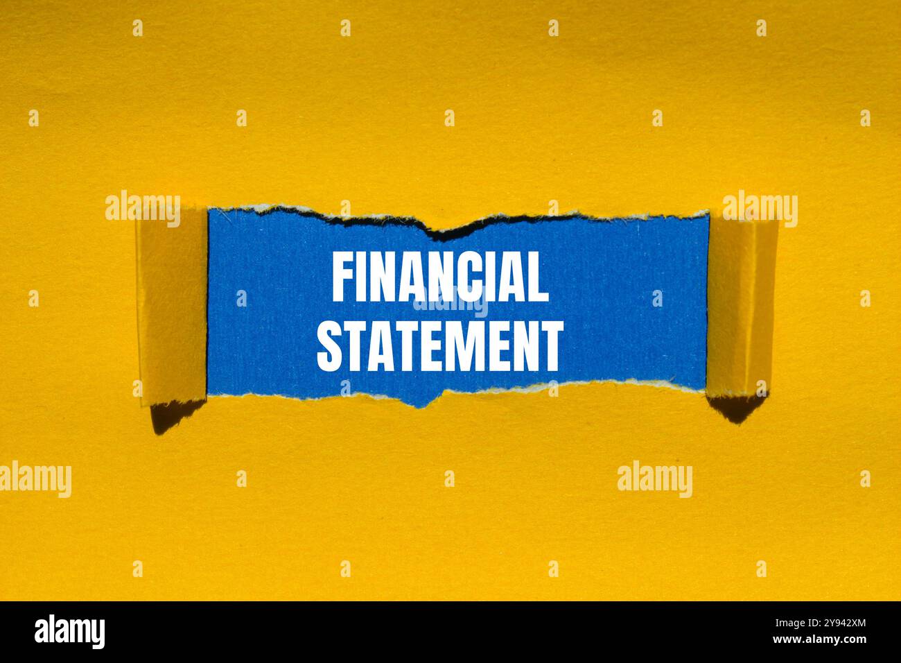 Financial statement message written on ripped torn yellow paper with ...