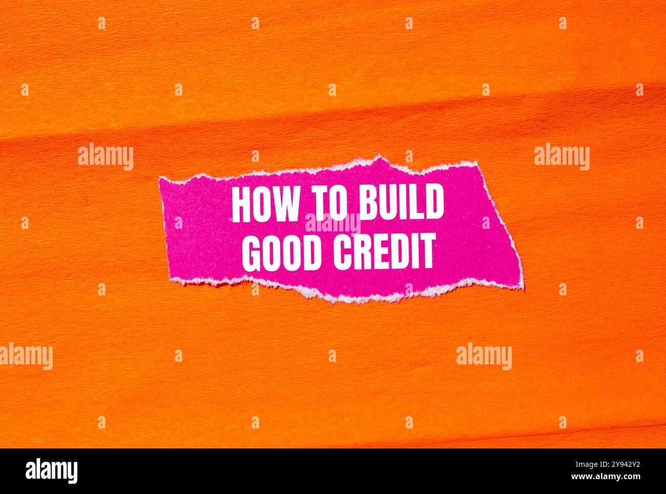 How to build good credit message written on ripped torn pink paper with ...