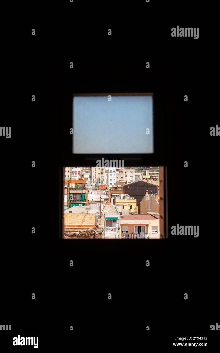 Morning view of Barcelona's dense, urban landscape seen through a dark ...