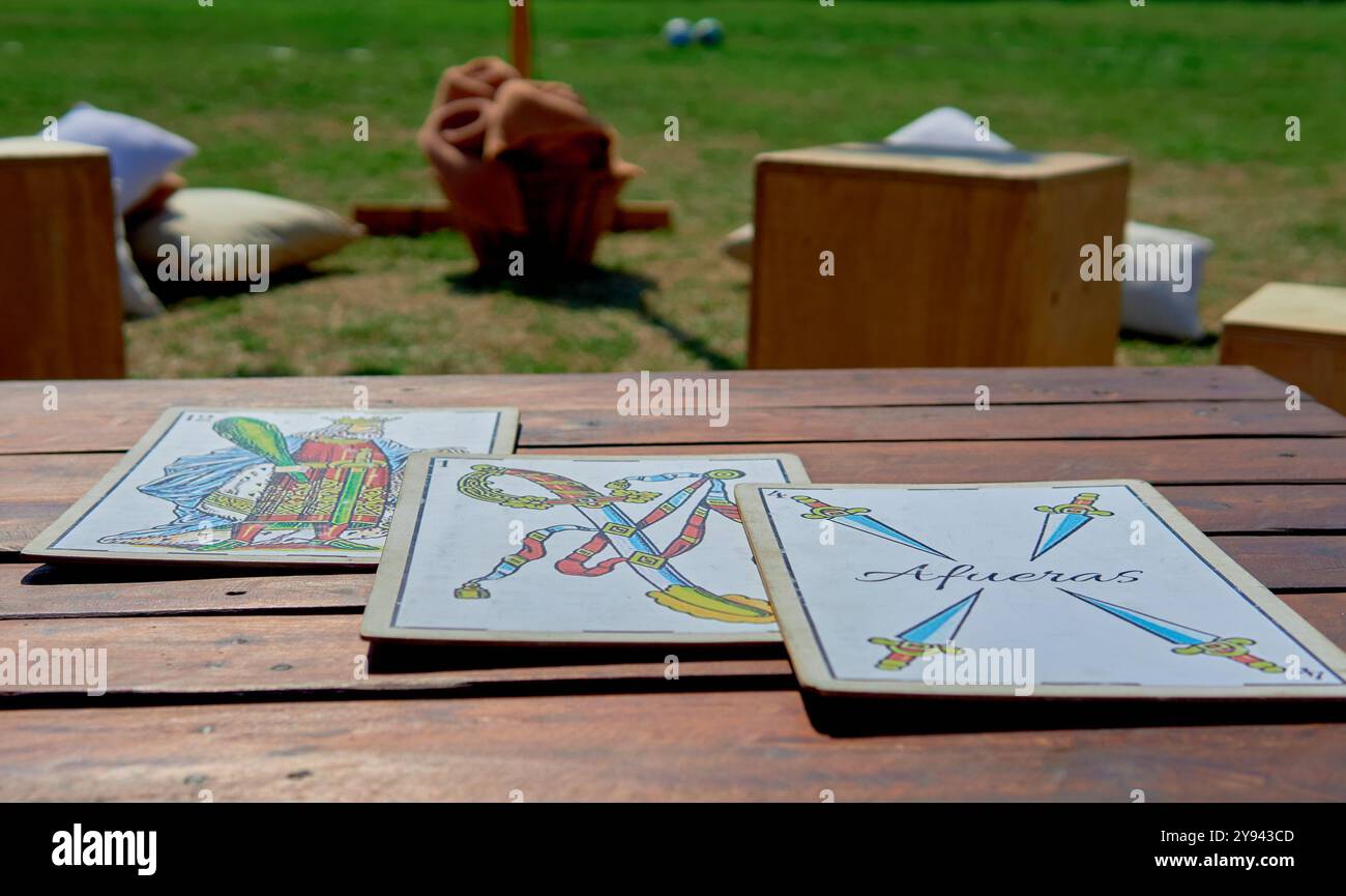 3 playing cards on a wooden table. Concept of an activity for children ...