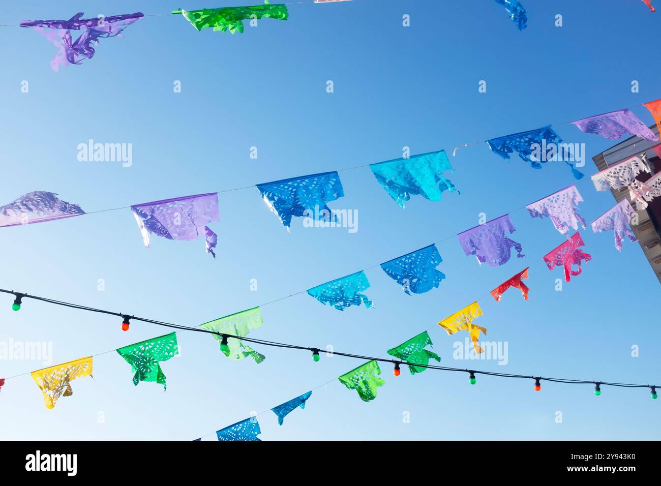 From below colorful paper cutout flags, typical of Mexican festivals ...