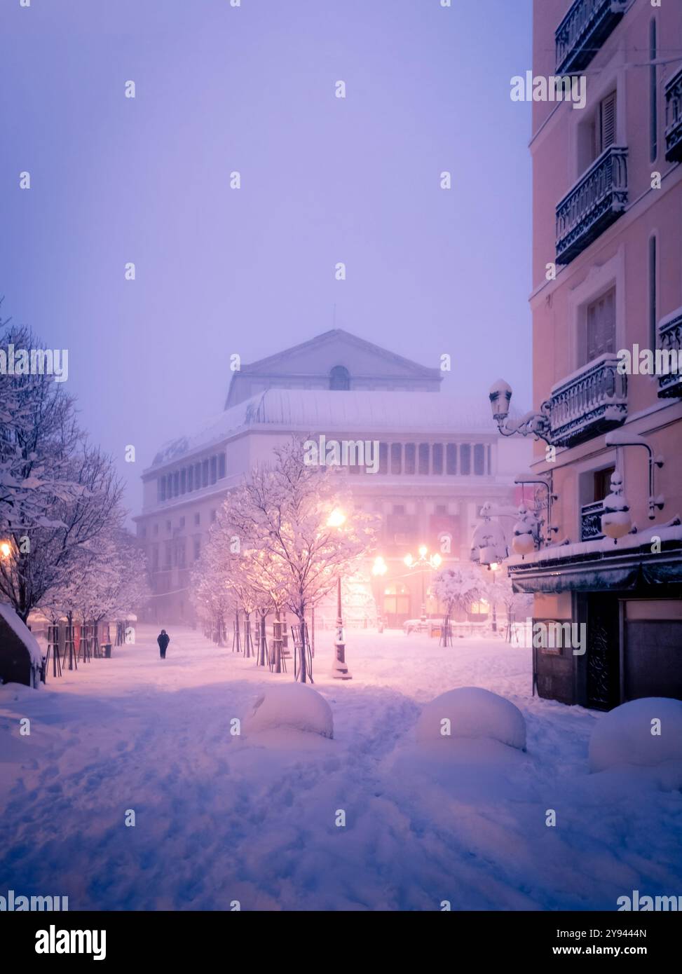 A serene snowy scene in Madrid, Spain, showing a snow covered street ...