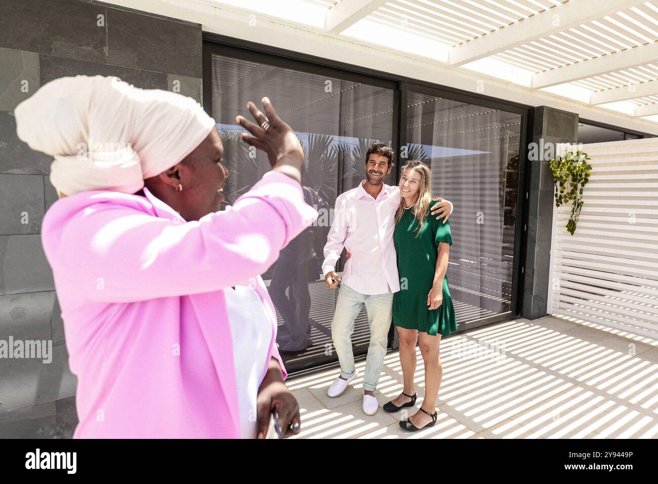 A black female real estate agent gestures goodbye after explaining ...