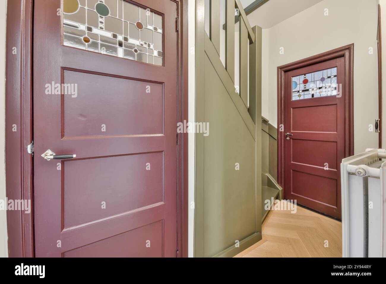 Inviting home entryway featuring a maroon door with stained glass ...