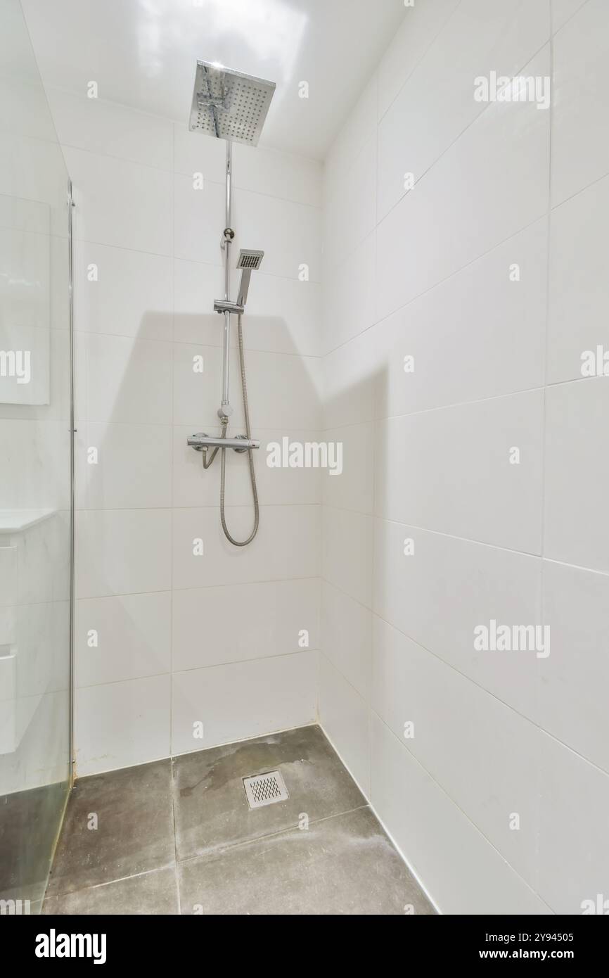 Modern shower corner with a large overhead and handheld showerhead in a ...