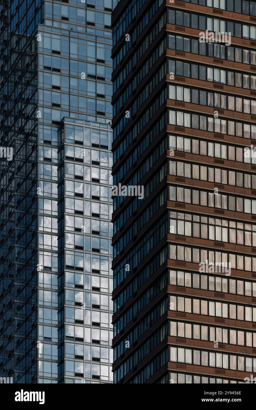 This image captures the sleek, modern facade of two high-rise buildings ...