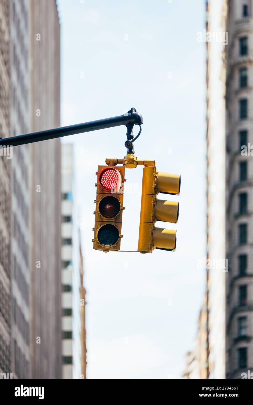 A red traffic light against the backdrop of New York City buildings ...