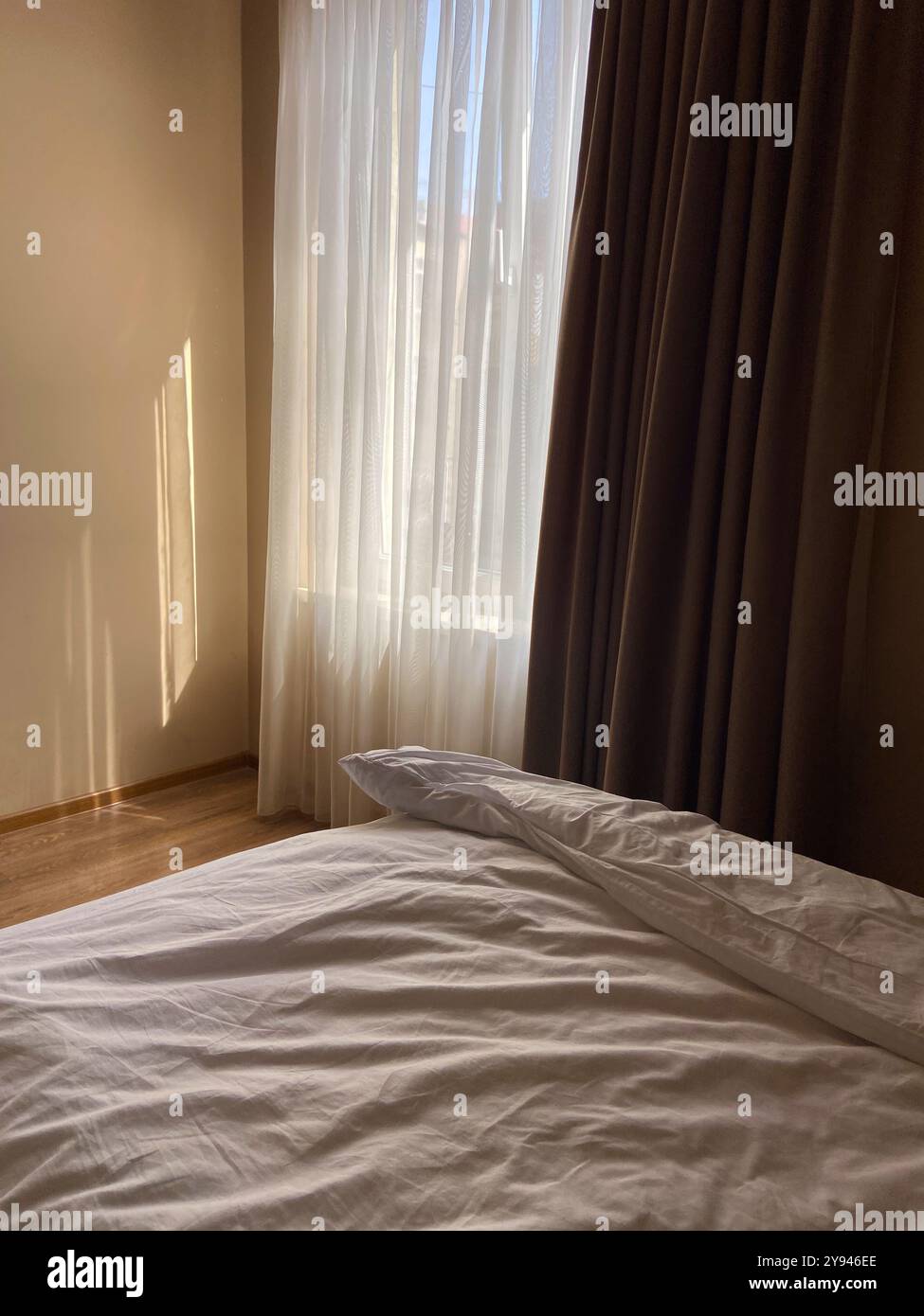 Messy bed with curtain and window view from bed Stock Photo - Alamy