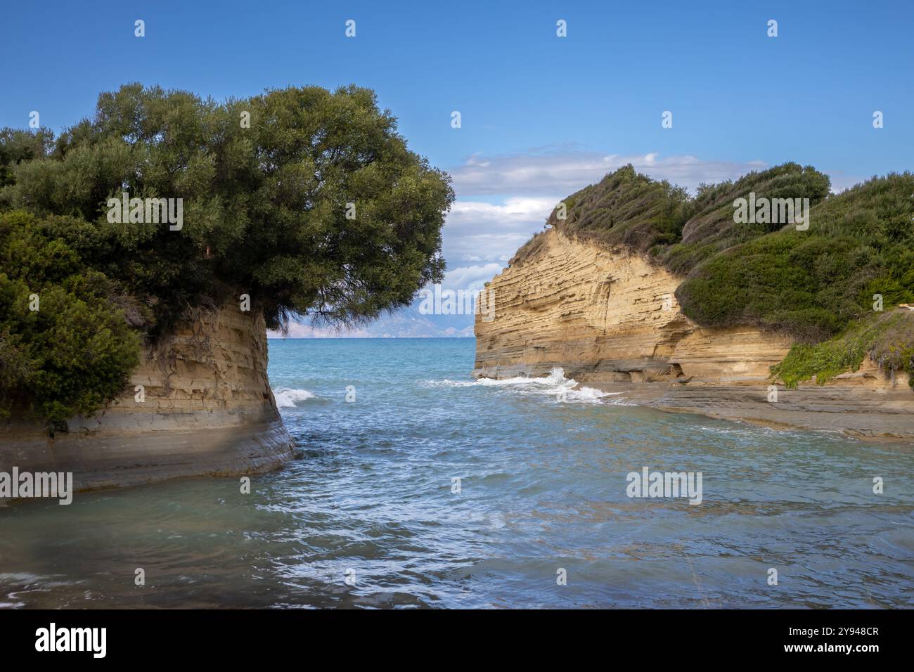 Sandstone cliffs, covered by fresh greenery, creating a bay Canal d ...