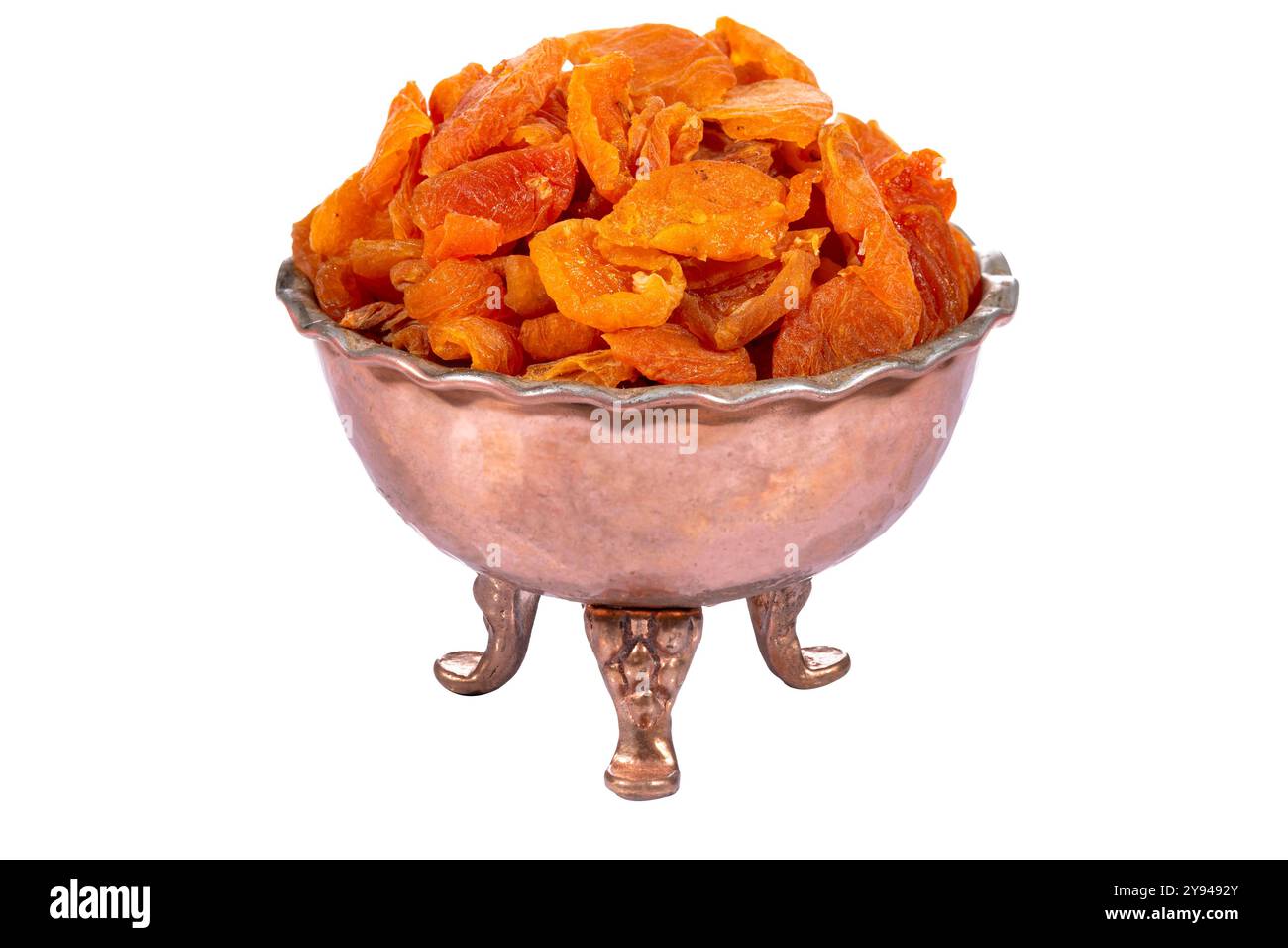 Sweet and juicy glazed apricots in a decorative copper bowl ...