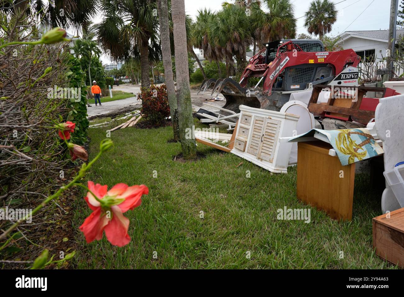 Teams work to clean up piles of debris from Hurricane Helene flooding ...