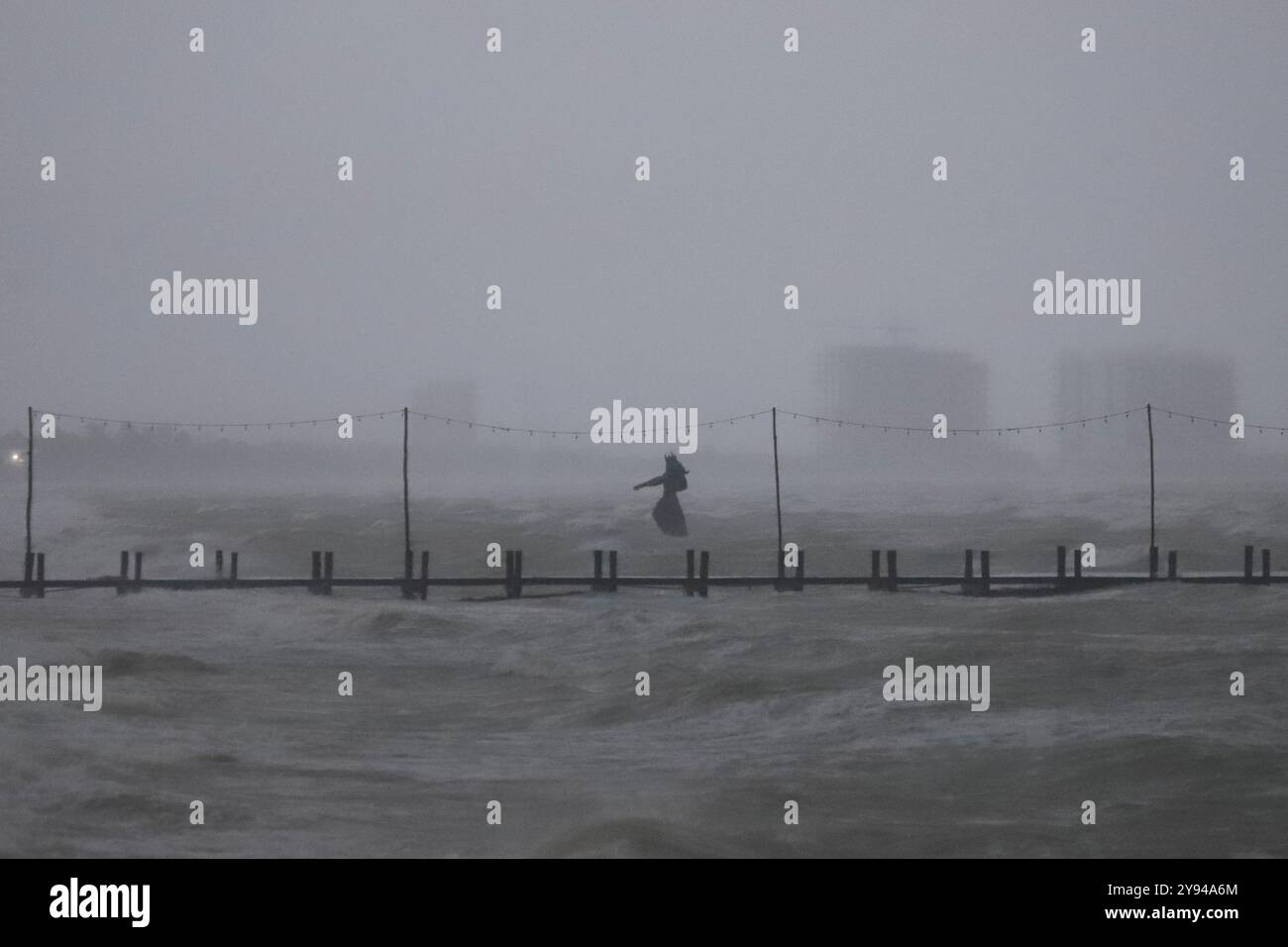A sculpture of Poseidon stands in the ocean after the eye of Hurricane ...
