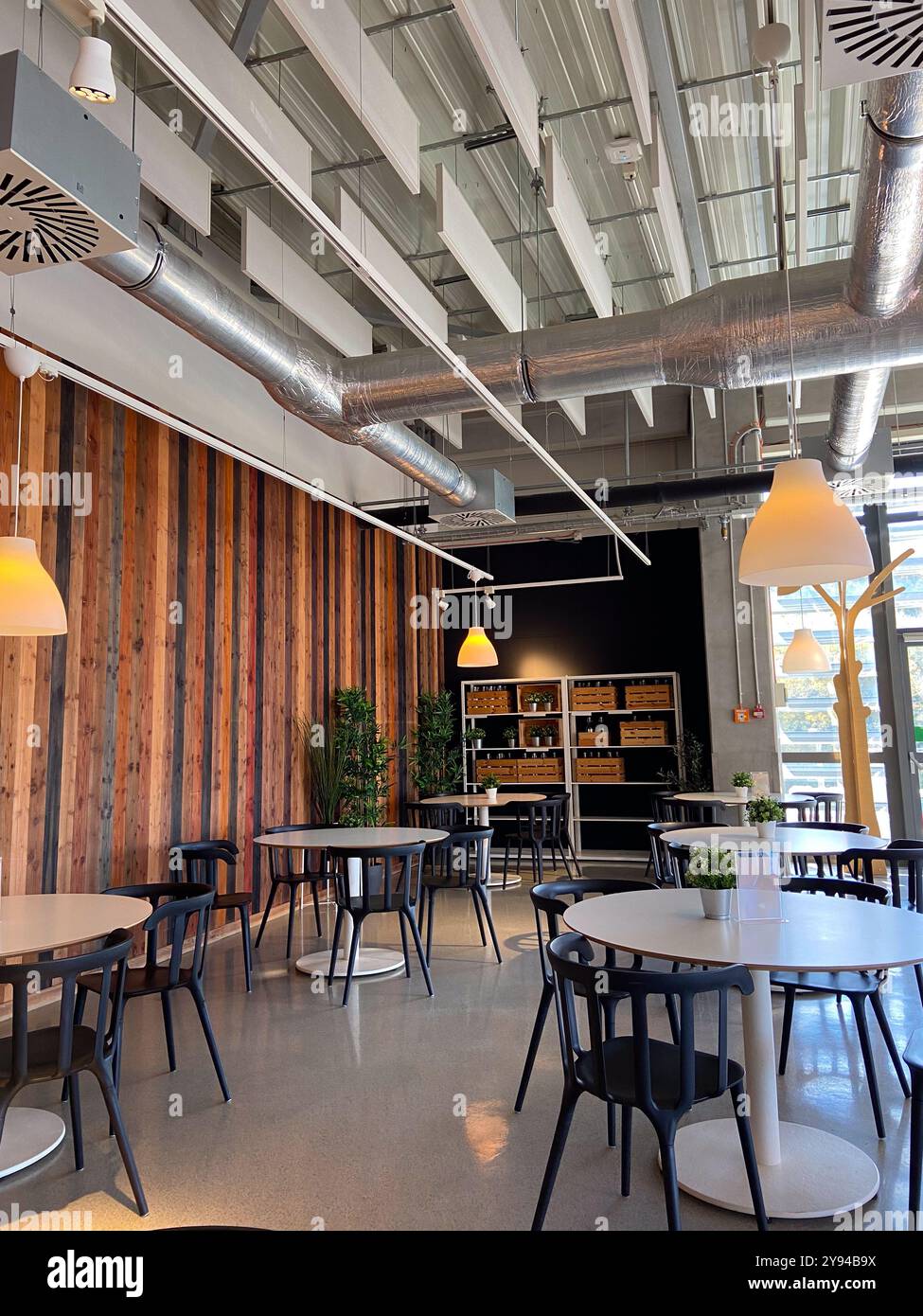 Modern cafe interior featuring sleek furniture, wooden panel walls, and ...