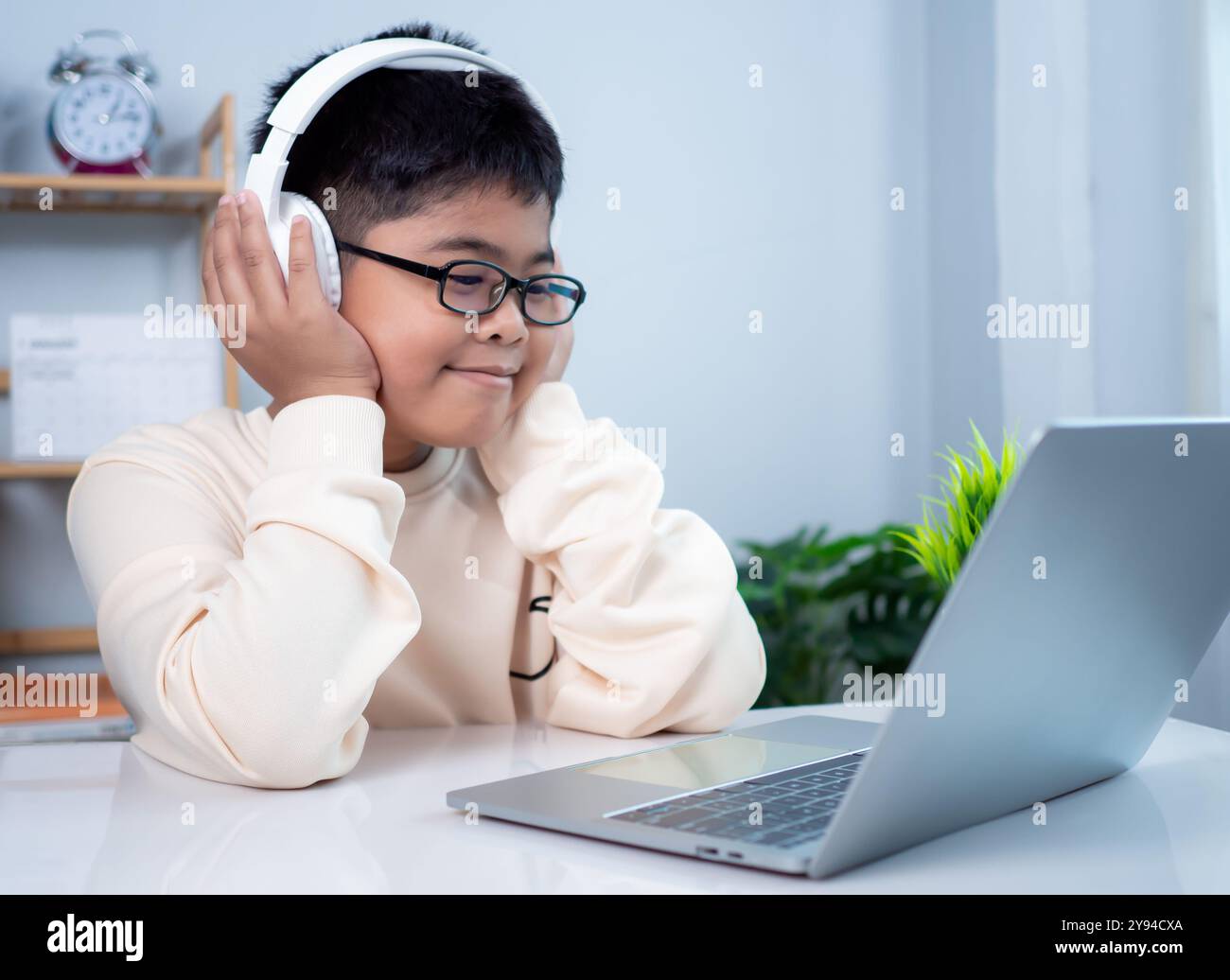 Asian student boy using headphones and computer learning. Educational ...