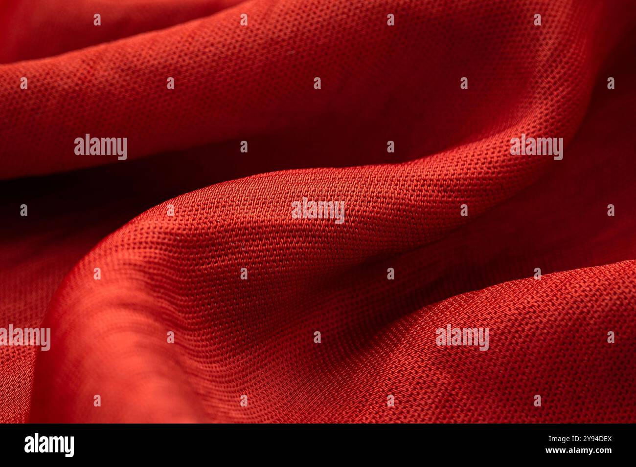 Detailed close-up of red fabric with visible weave and fine texture ...