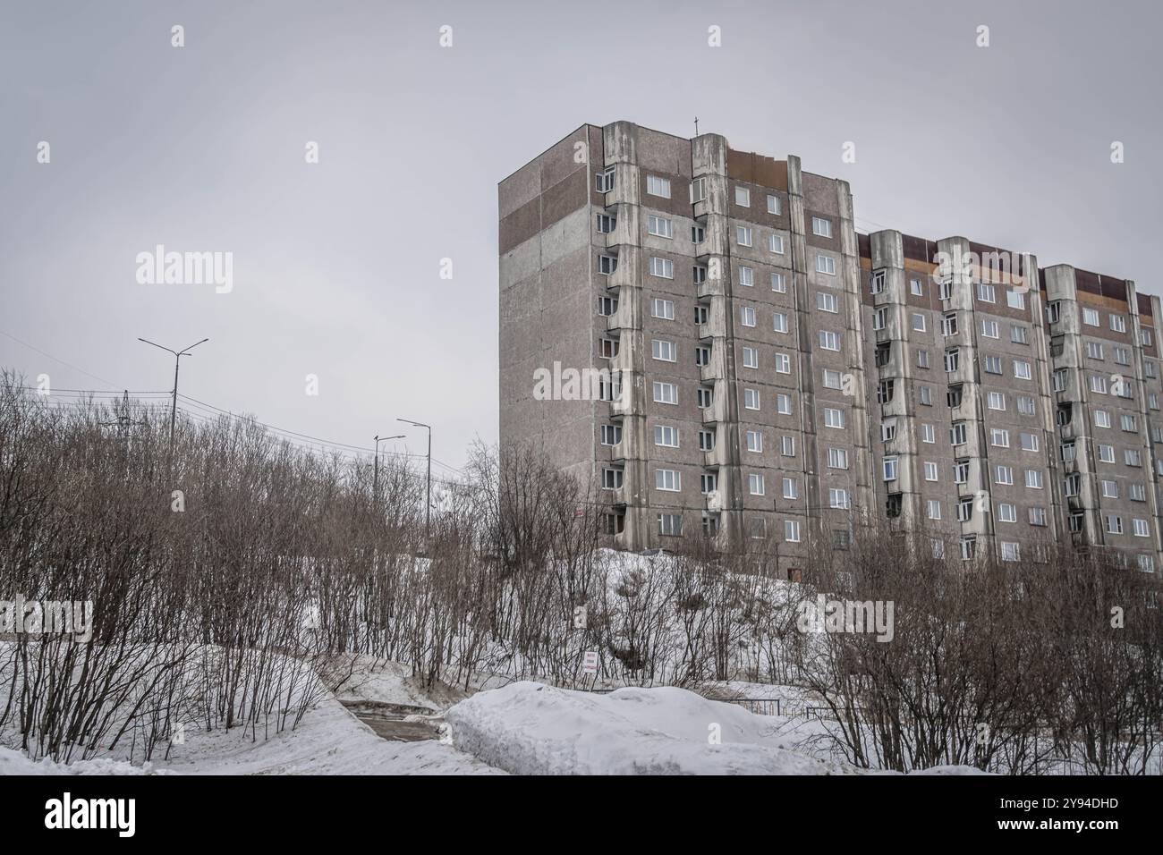The socialism-era panel building on the snowy hill at Murmansk, Russian ...