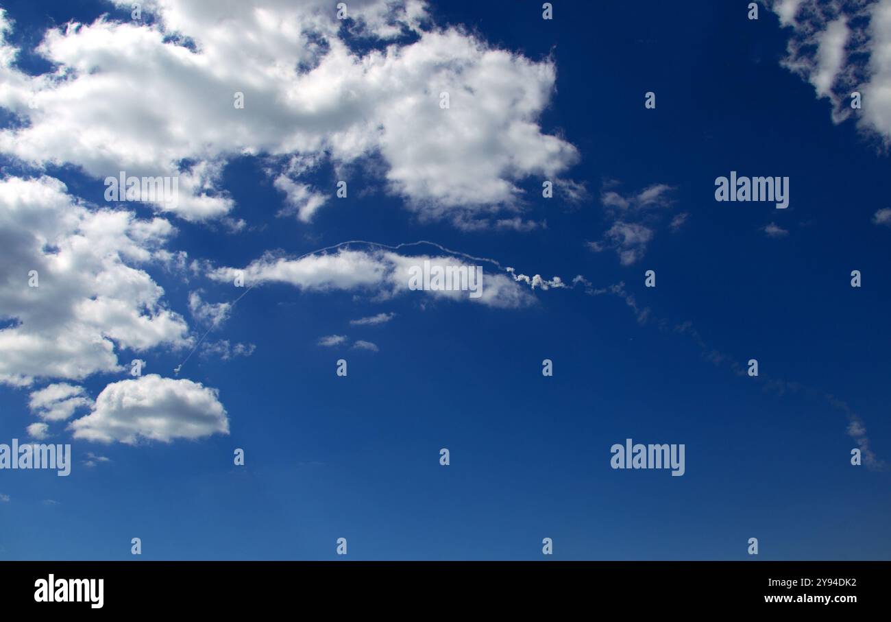 Blue Sky with White Tracer Missile Trail Over City Buildings During ...