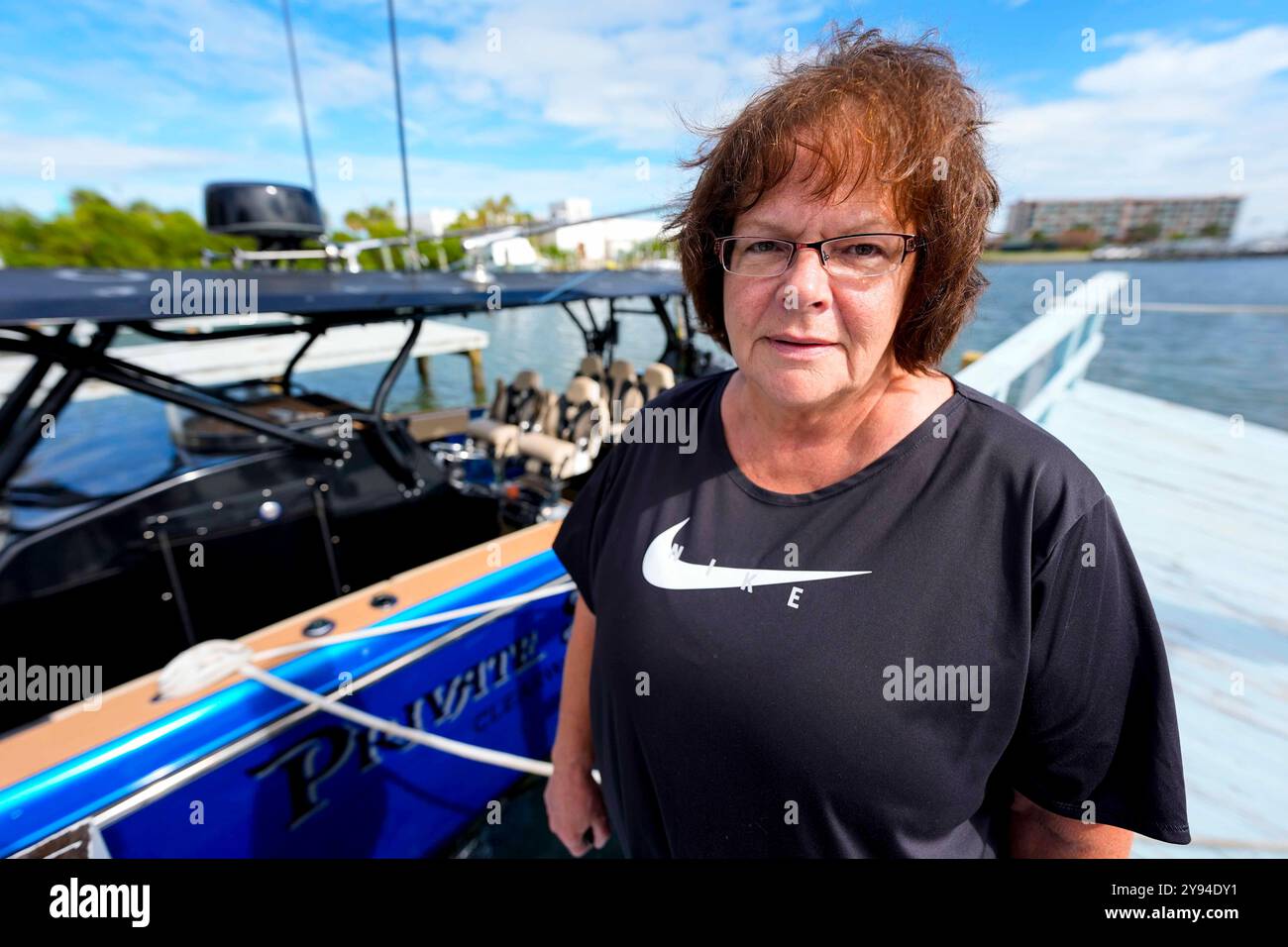 Debi Jones of Clearwater, Fla., stands next to her 44-foot boat ...
