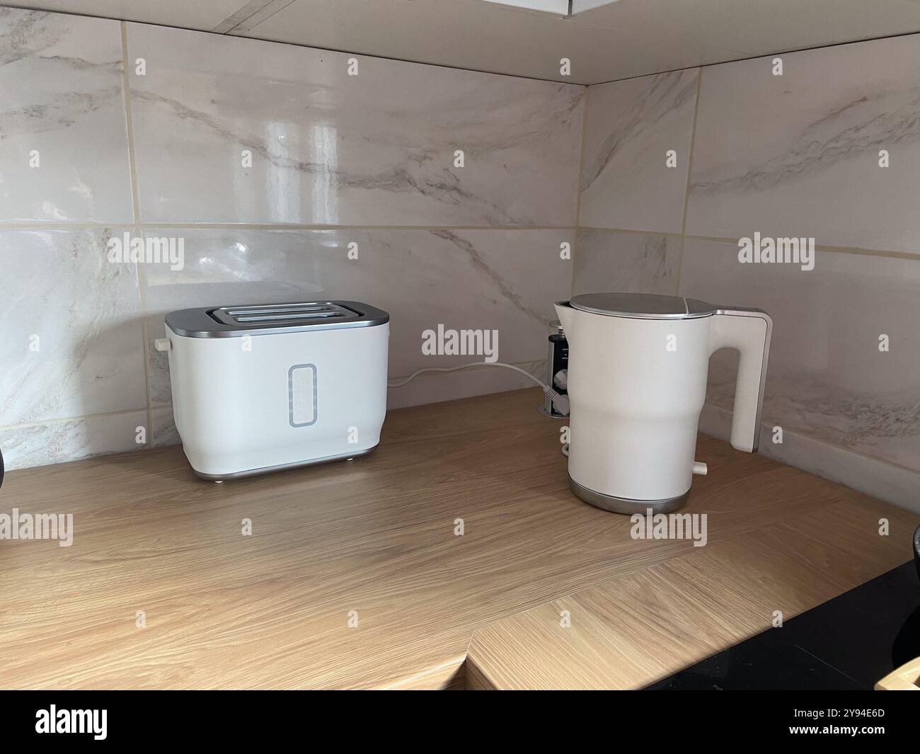 Modern kitchen nook featuring a sleek toaster and electric kettle on a ...