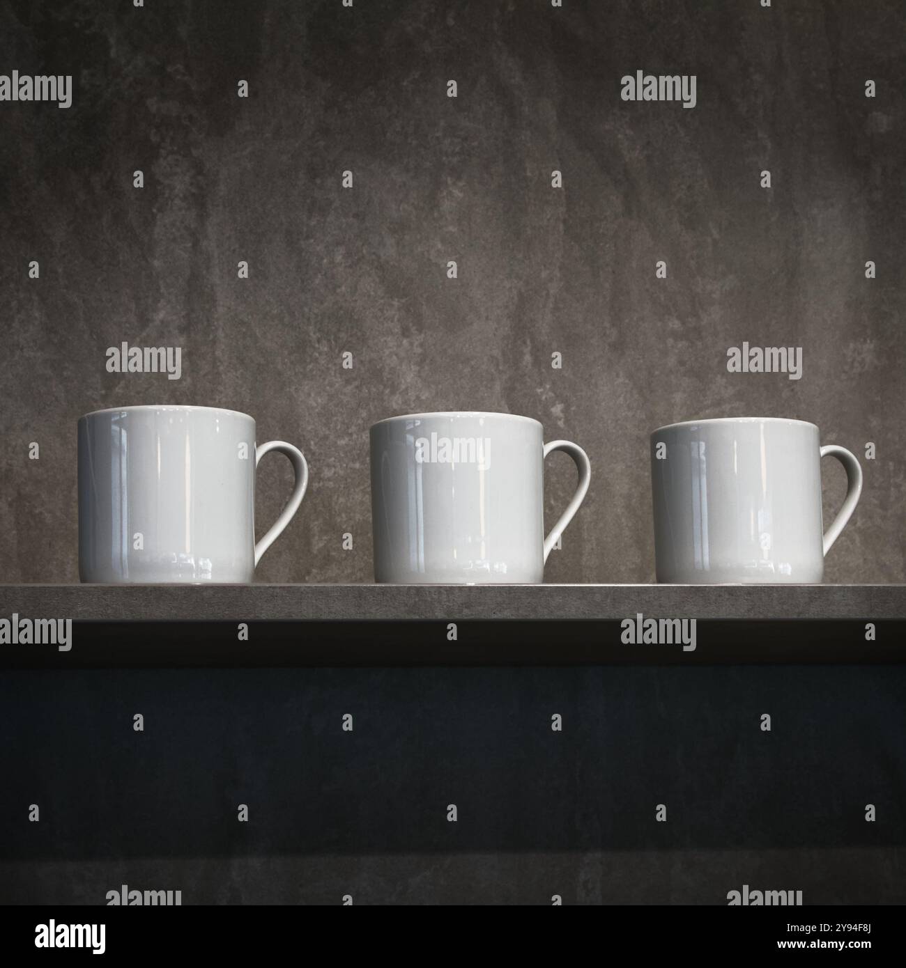 Three White Coffee Mugs, Cups With Handles On Display On A Wall Shelf ...
