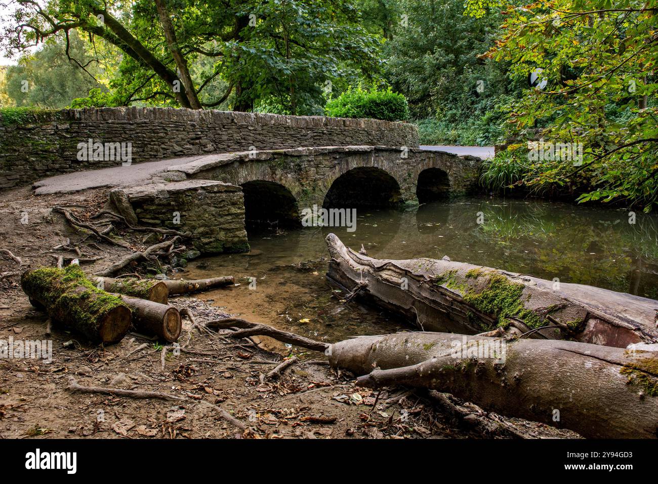 ByBrook River and stone bridge at Castle Combe village in the Cotswolds ...