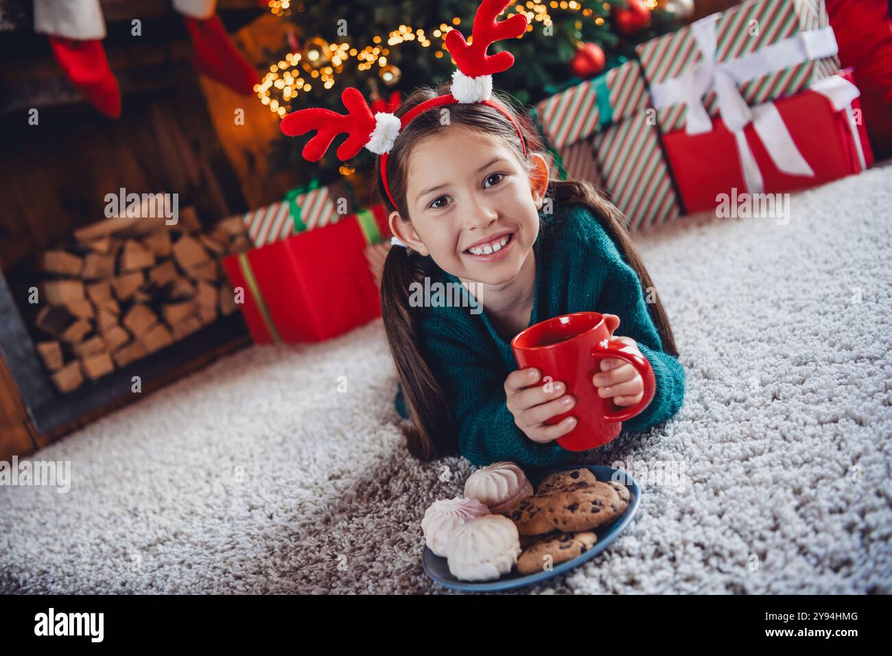 Full size photo of cute little girl lying floor snacks cacao dressed ...
