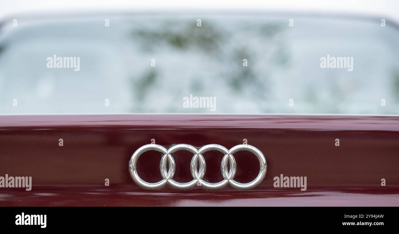 Close up of the Audi logo on a maroon car, showcasing the brand's ...