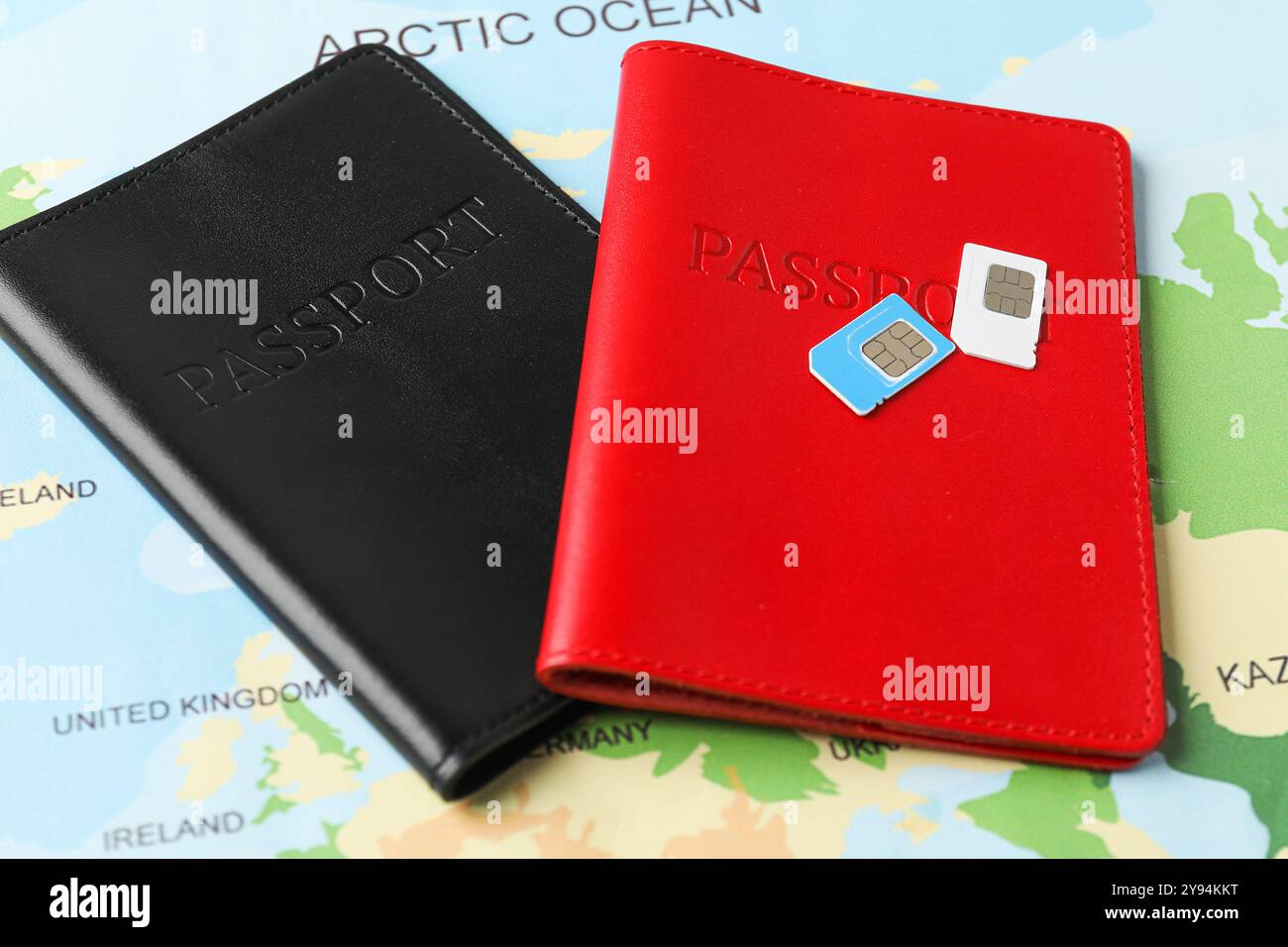 Passports and SIM cards on world map Stock Photo - Alamy