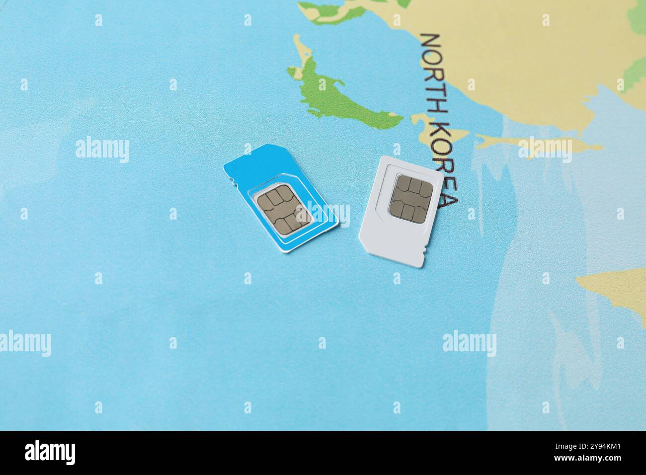 SIM cards on world map, above view Stock Photo - Alamy