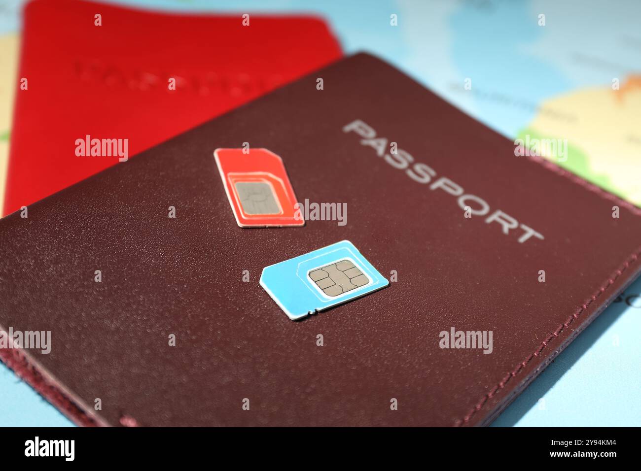 Modern SIM cards and passports on world map, closeup Stock Photo - Alamy