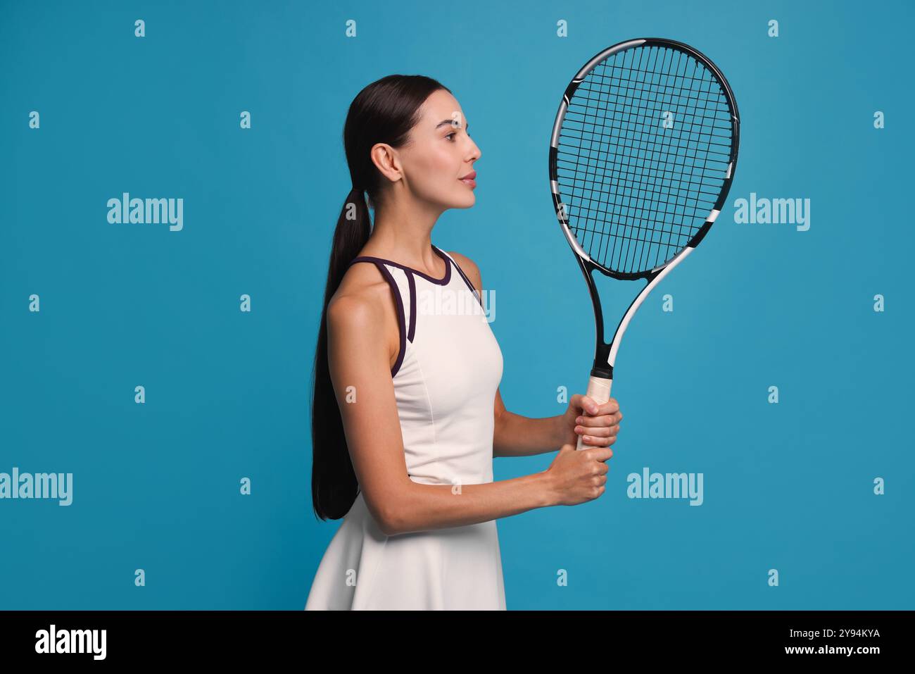 Beautiful young woman with tennis racket on light blue background Stock ...